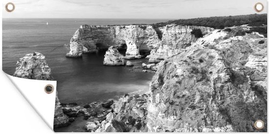 Schuttingposter Water aan de rotsen van de Benagil zeegrot in Algarve ...