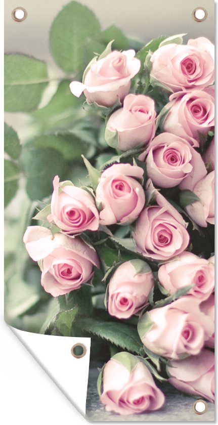 Poster de jardin Un grand livre de roses roses est posé sur une table ...