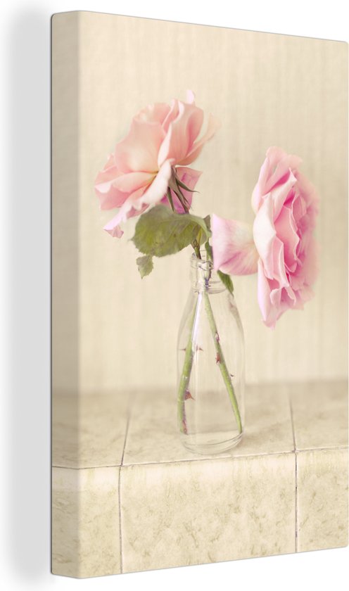 Canvas Schilderij Twee roze rozen als decoratie in een glazen flesje ...