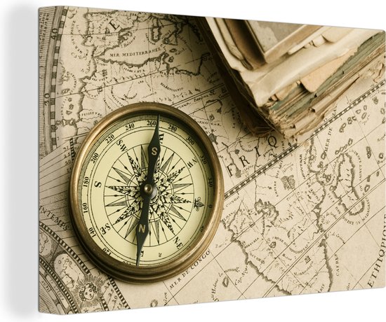 Canvas Schilderij Oud kompas om mee te navigeren op een oude kaart ...