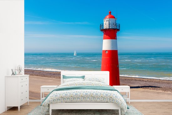 Behang - Fotobehang Rood met witte vuurtoren op het strand van ...