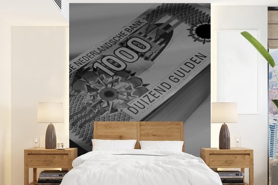 Behang - Fotobehang Close-up van een stapel gulden bankbiljetten van ...