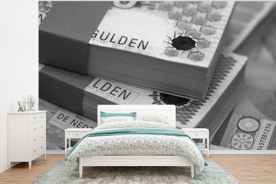 Behang - Fotobehang Een close-up van verschillende stapels gulden van ...