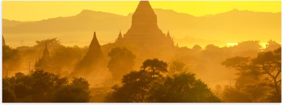 Poster (Mat) - Schermige Zon achter Tempels - 90x30 cm Foto op ...